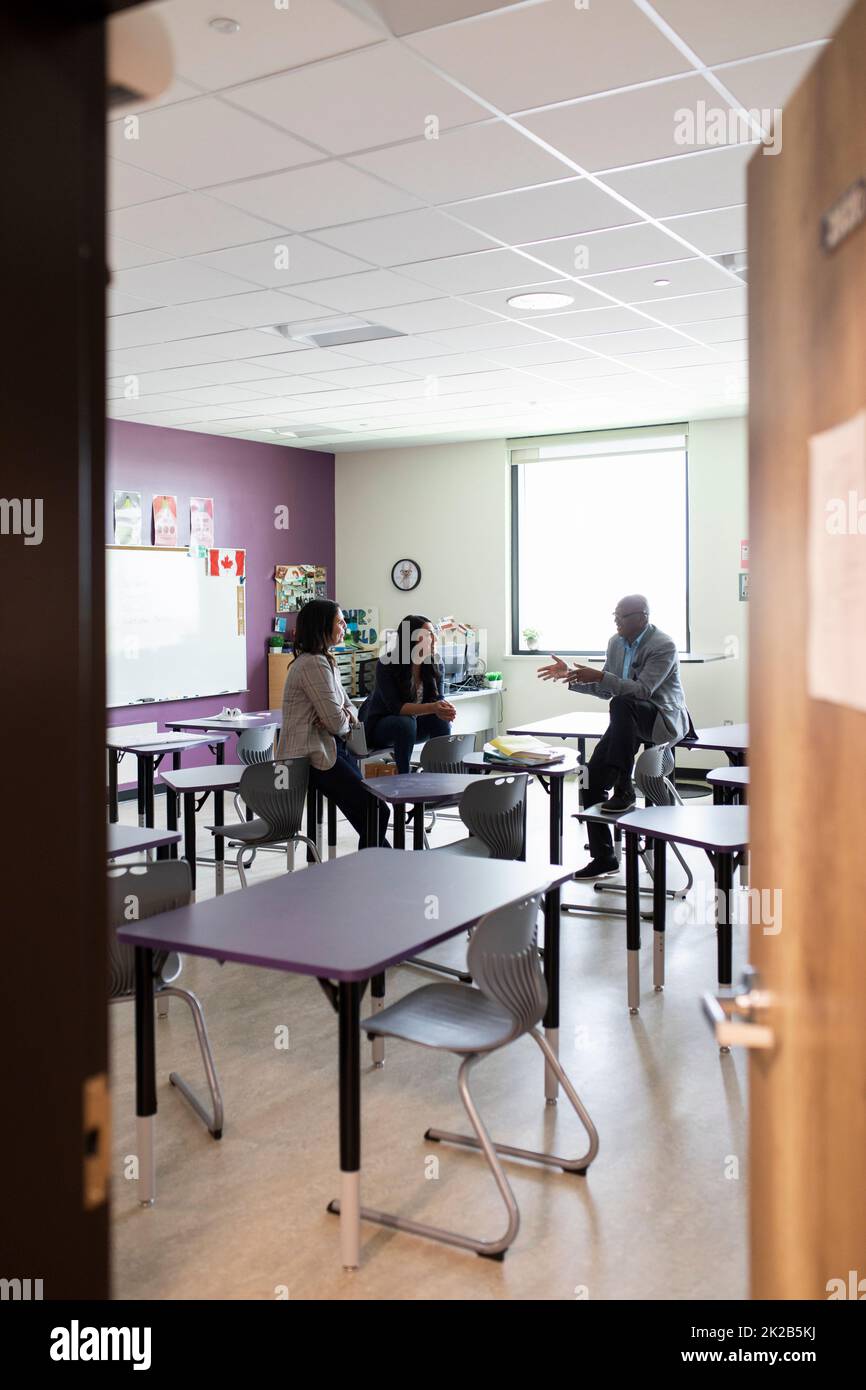 Three teachers talking hi-res stock photography and images - Alamy