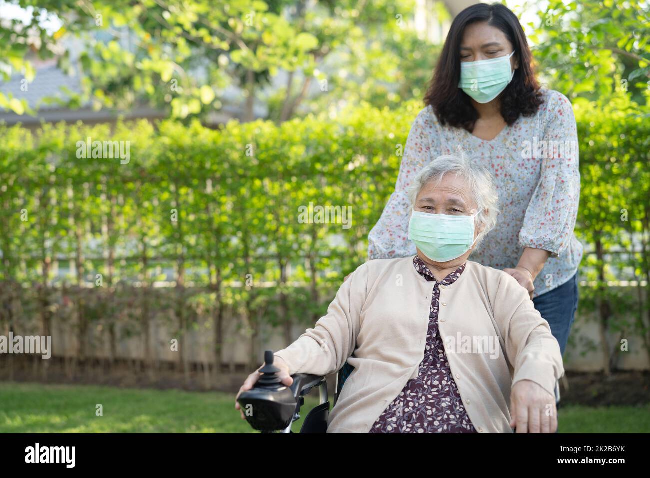 Help Asian senior or elderly old lady woman on electric wheelchair and ...