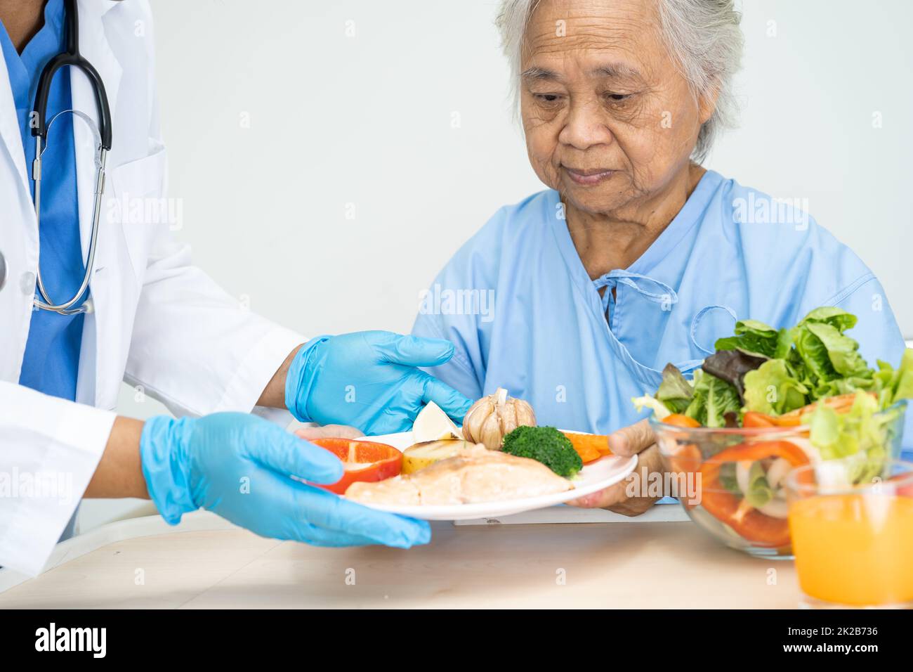 Asian senior or elderly old lady woman patient eating breakfast and ...