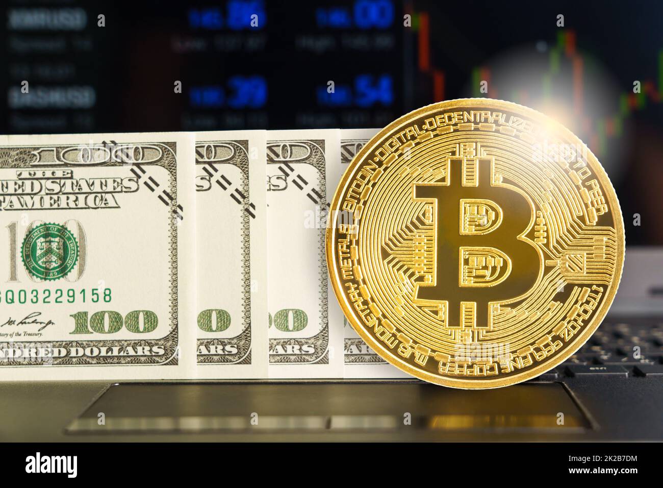 Bitcoins coin and banknotes on keyboard compute with market price chart ...