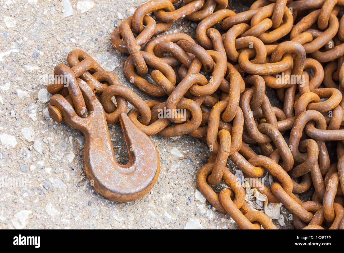 Rusty hook and chain on floor Stock Photo - Alamy