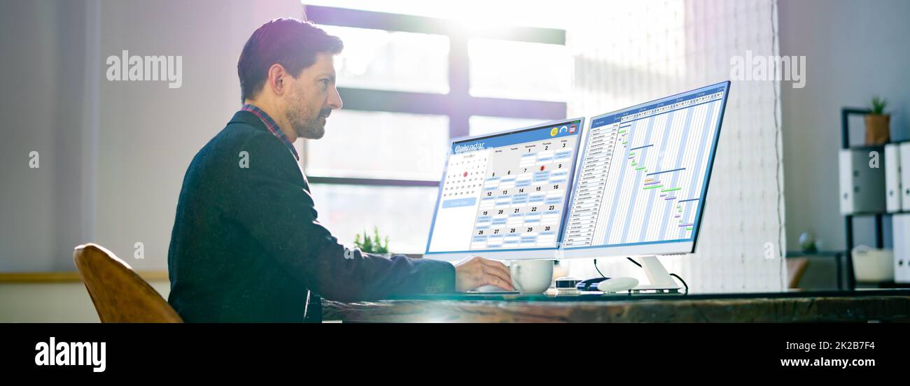 Businessman Checking Calendar On Computer Screen Stock Photo - Alamy