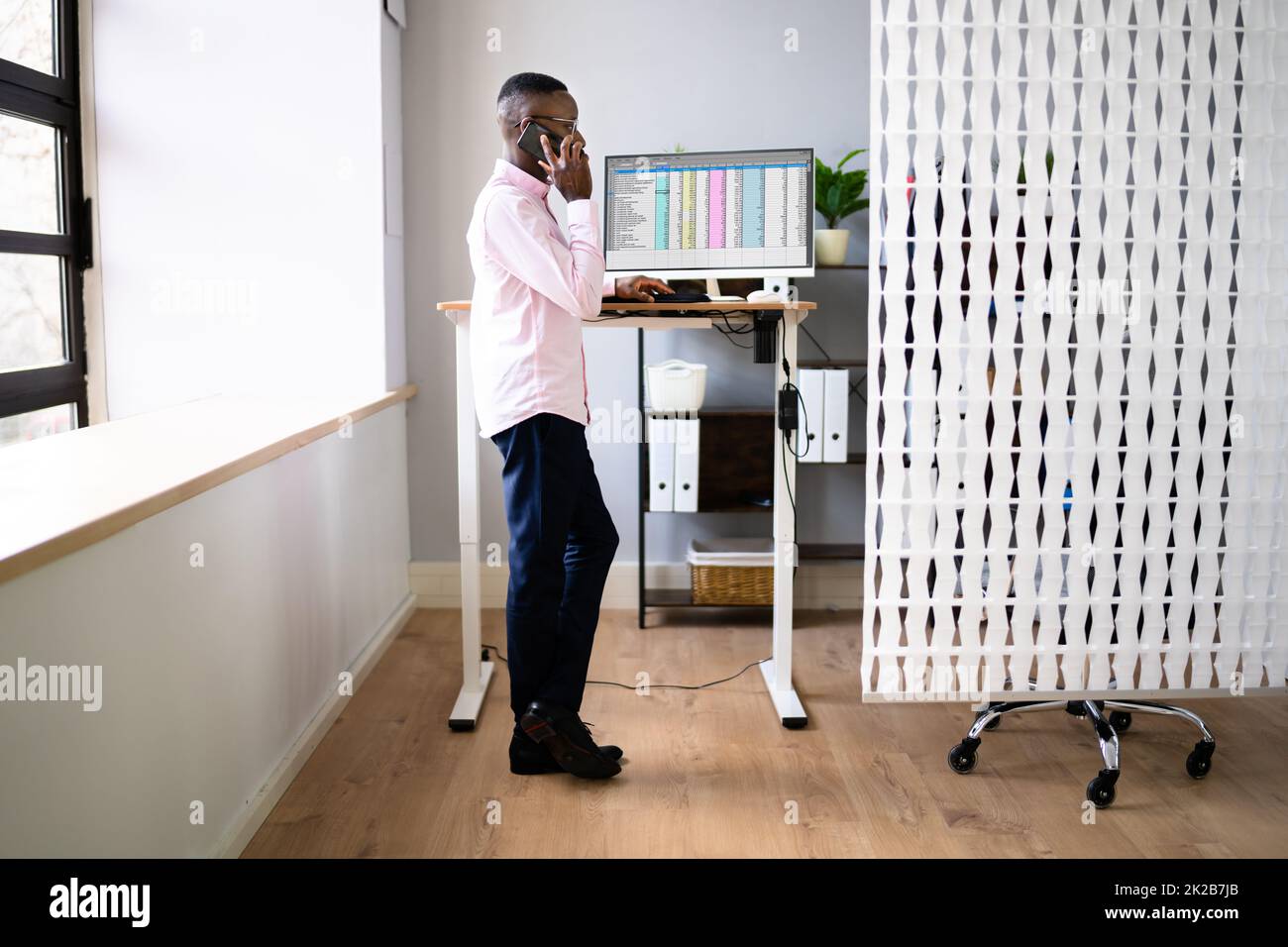 Adjustable Height Desk Stand In Office Stock Photo - Alamy