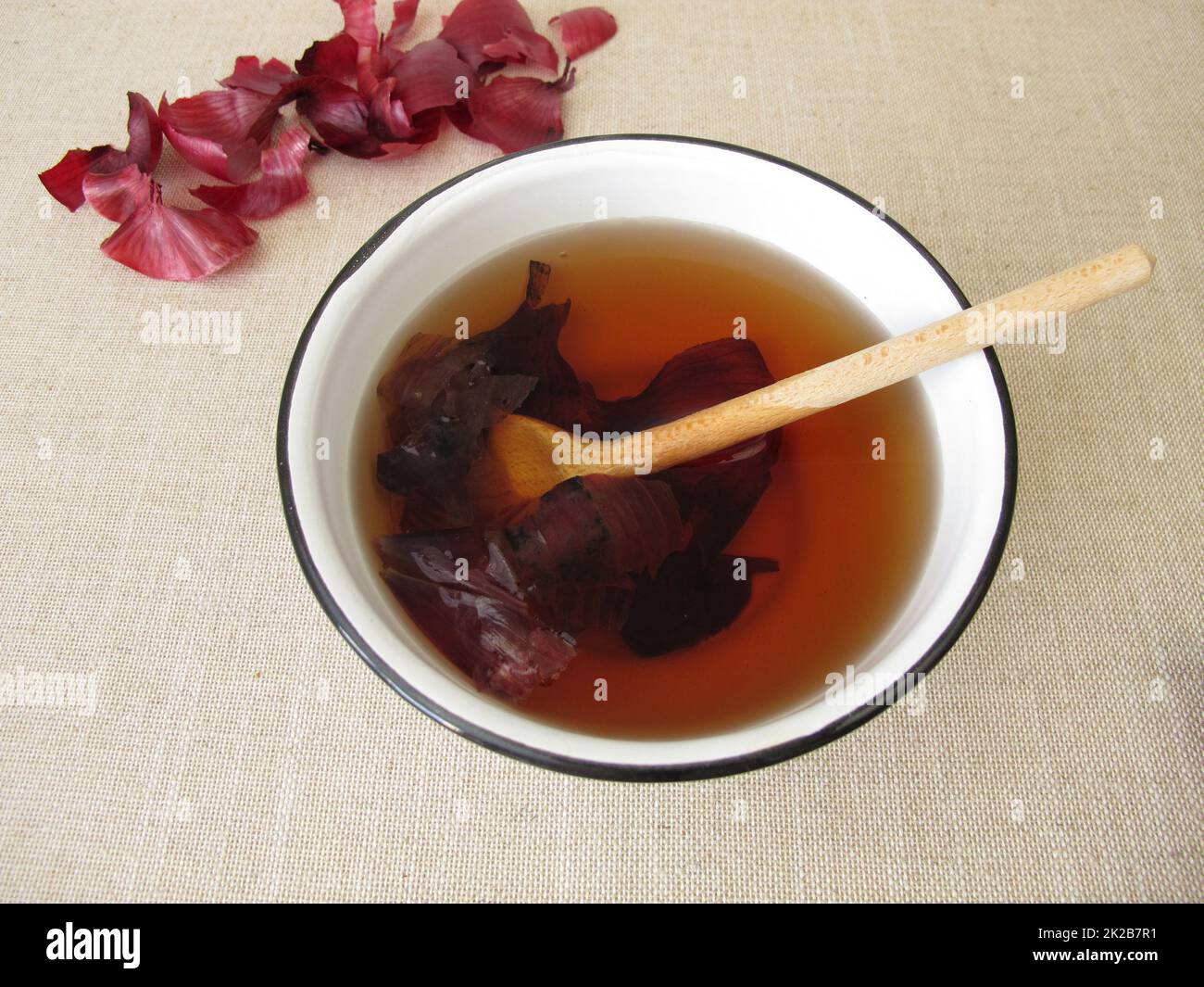 Dye agent, red decoction from red onion peel in a bowl Stock Photo - Alamy