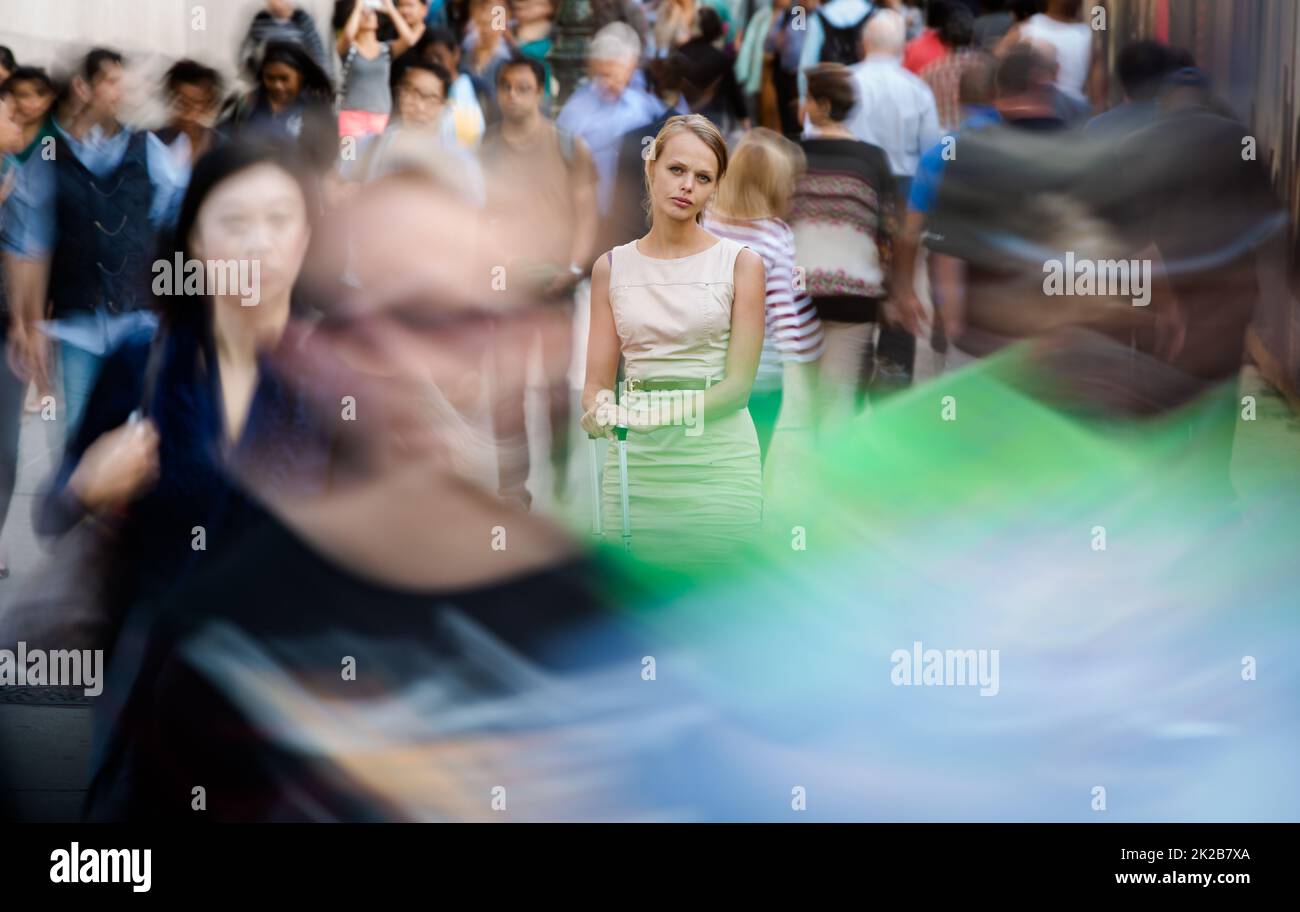 Crowd of people walking on city street - motion blurred image with ...