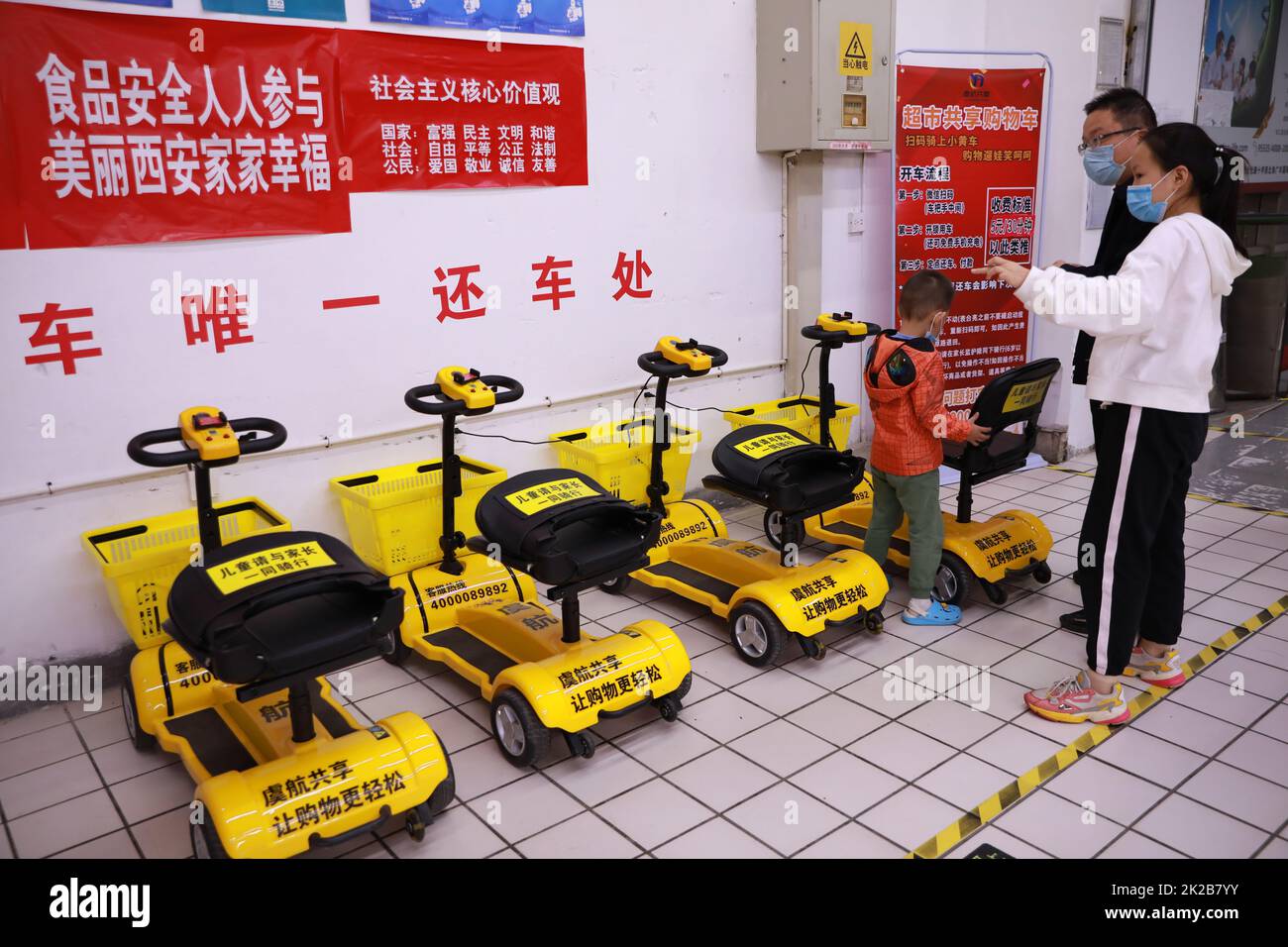 XI'AN, CHINA - SEPTEMBER 22, 2022 - Citizens ride shared shopping carts ...