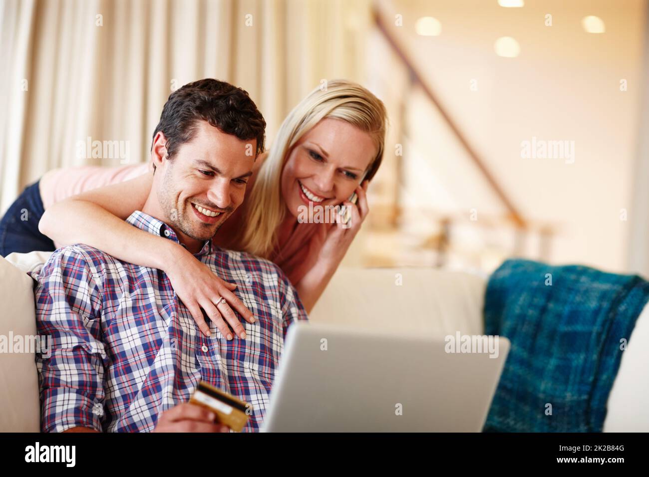 Shopping From The Comfort Of Our Couch A Beautiful Woman Hugging Her