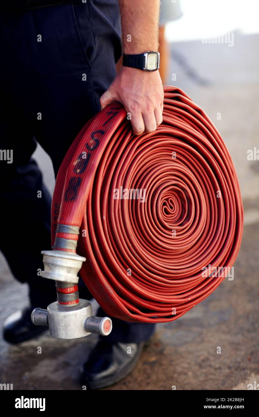Fireman holding water hose hi-res stock photography and images - Alamy