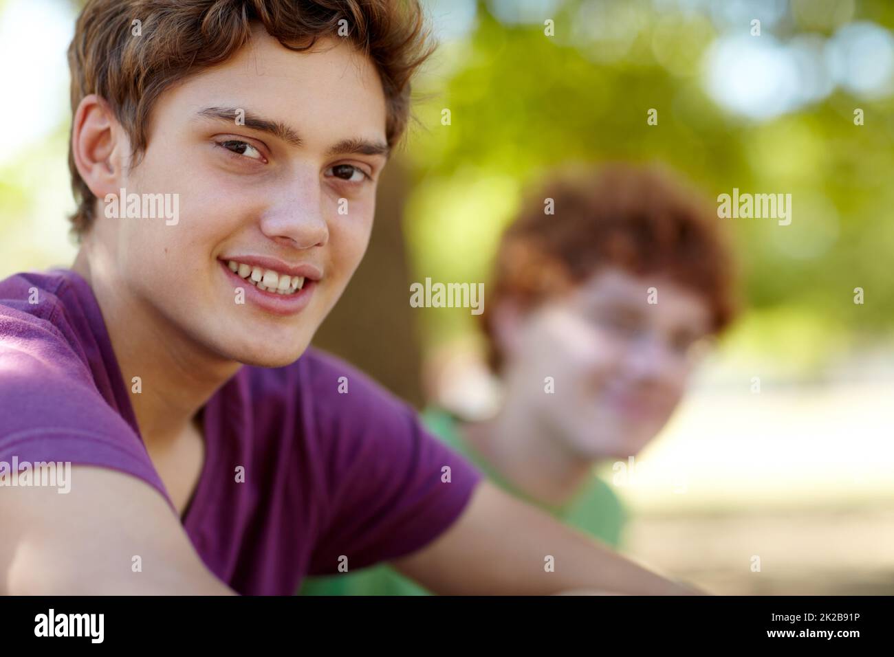 Two boys sitting in park hi-res stock photography and images - Alamy