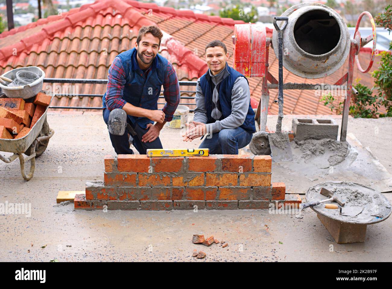 The beginnings of a sound foundation. Portrait of bricklayers at work ...