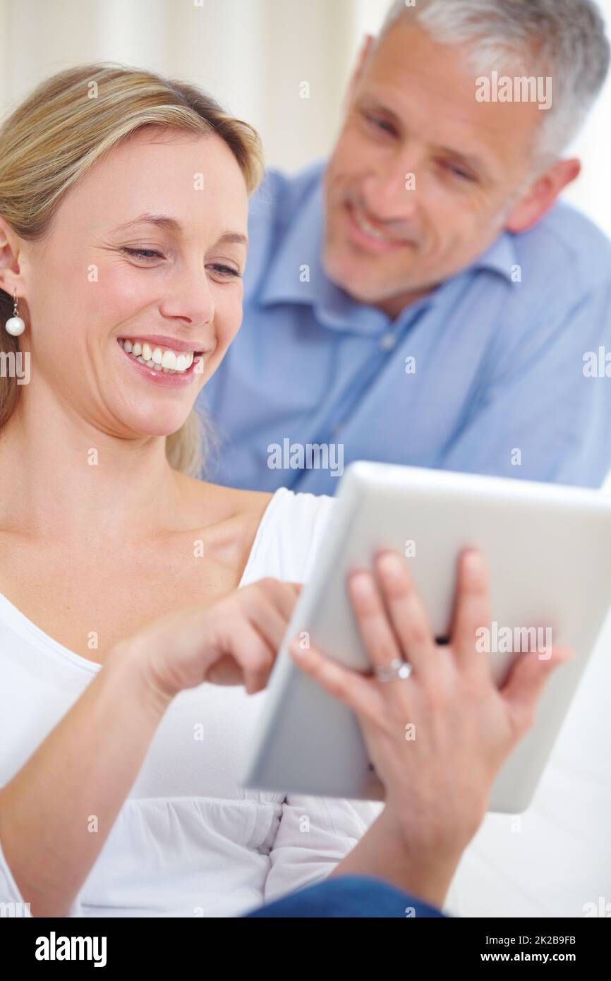 Check Out These Features An Attractive Young Woman Using Her Digital Tablet With Her Husband