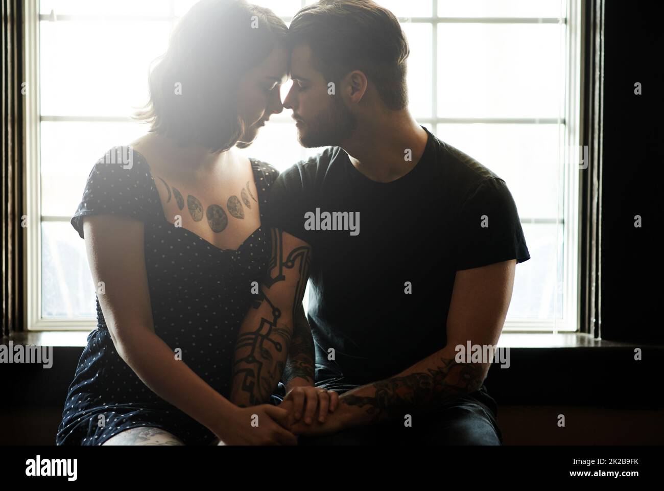 I really want to kiss you. Shot of an affectionate young couple sitting ...