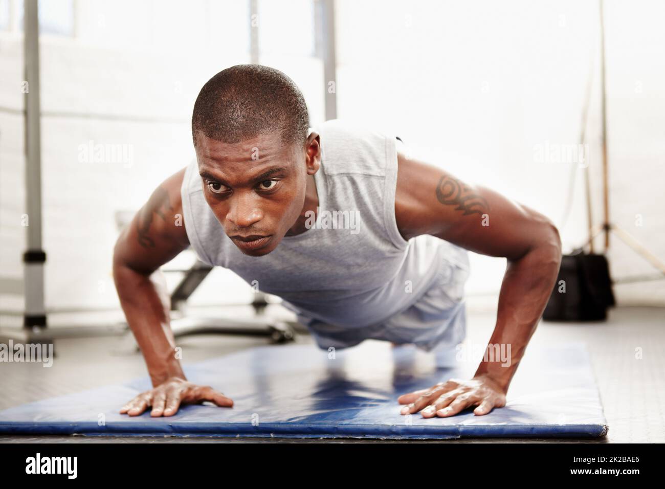Only 10 to go. Seriously focused man doing push ups in a gym Stock ...