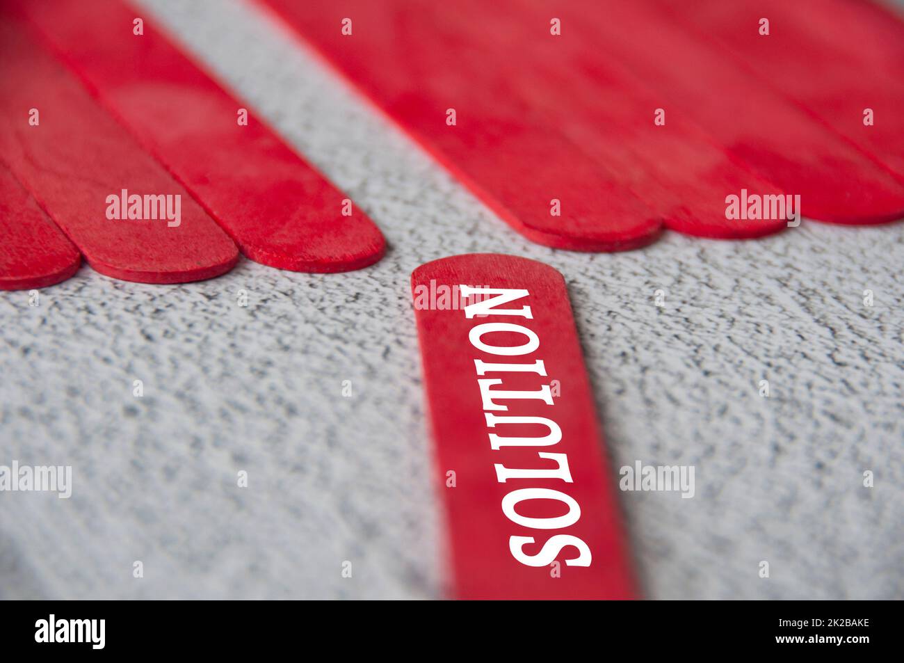 Solution text on red wooden stick separated from the rest of the sticks ...