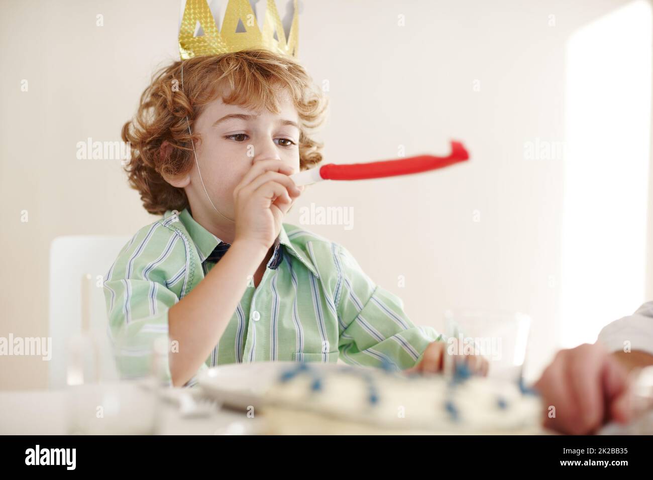 Child blowing horn hi-res stock photography and images - Alamy