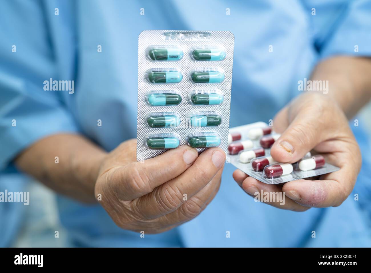 Asian senior or elderly old lady woman patient holding antibiotics ...