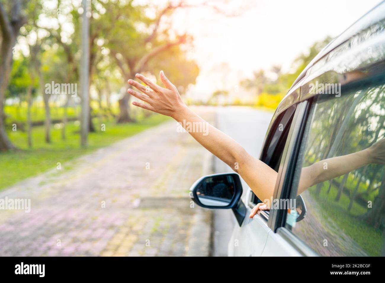 Happy enjoy and freedom in traveling trip with raised hand out of ...