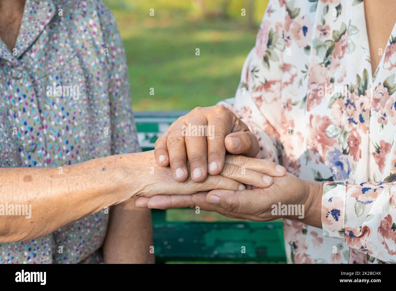 Caregiver holding hands Asian senior or elderly old lady woman patient with love, care ...