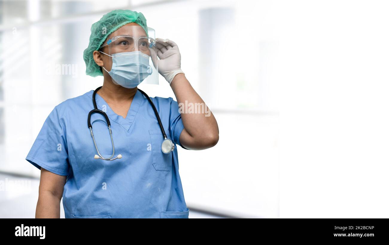 Asian doctor wearing face shield and PPE suit new normal to check ...