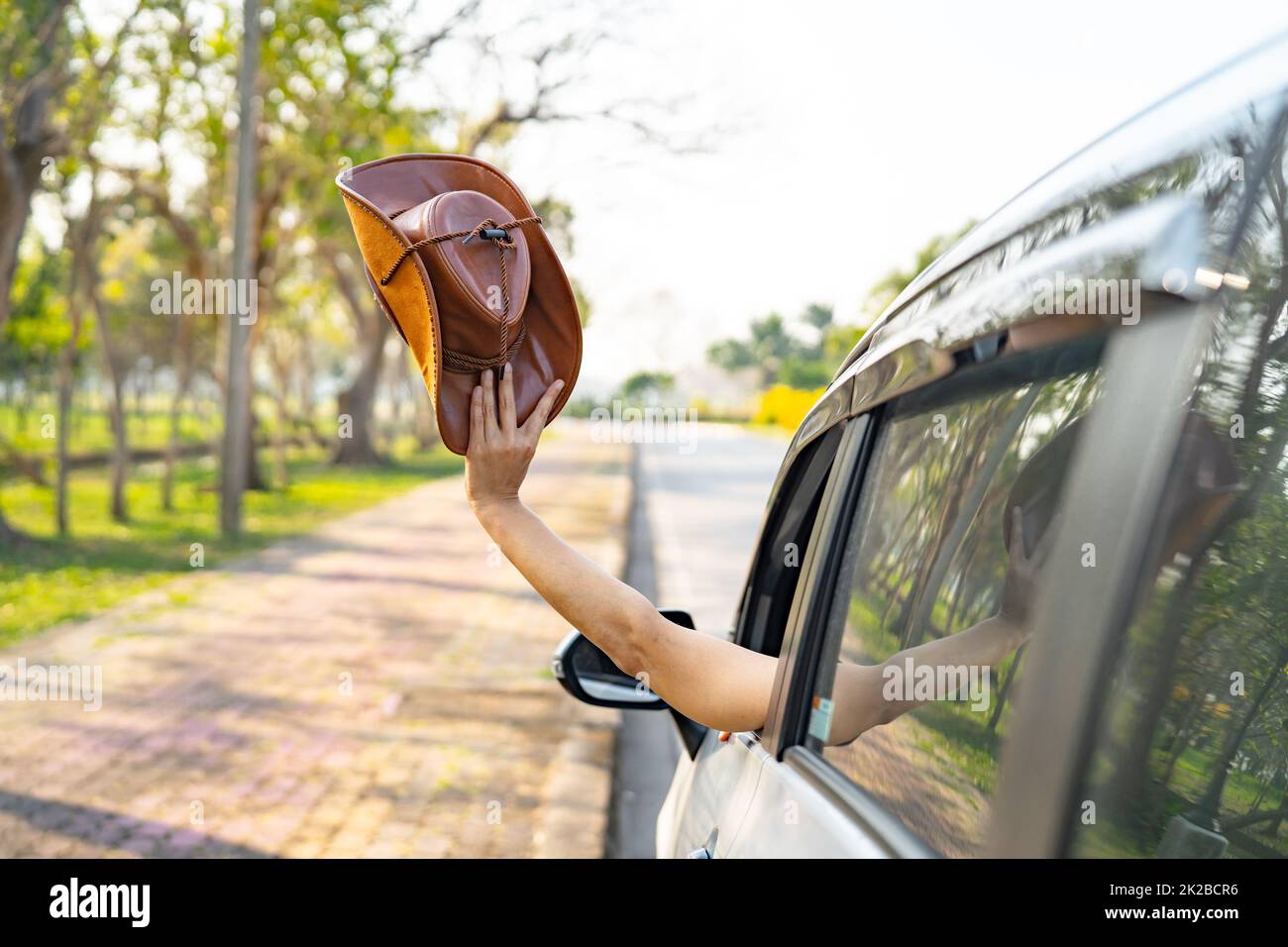 Happy enjoy and freedom in traveling trip with raised hand and holding ...