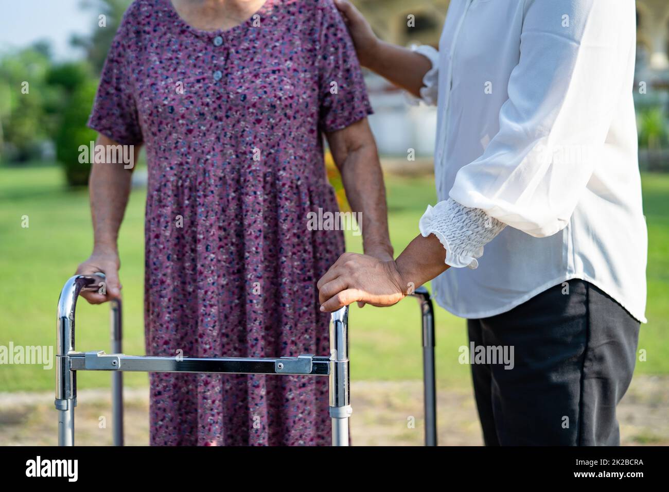 Help and care Asian senior or elderly old lady woman use walker with ...