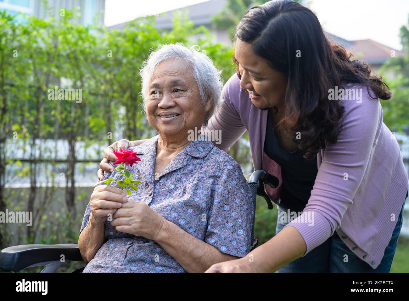 Caregiver daughter hug and help Asian senior or elderly old lady woman ...