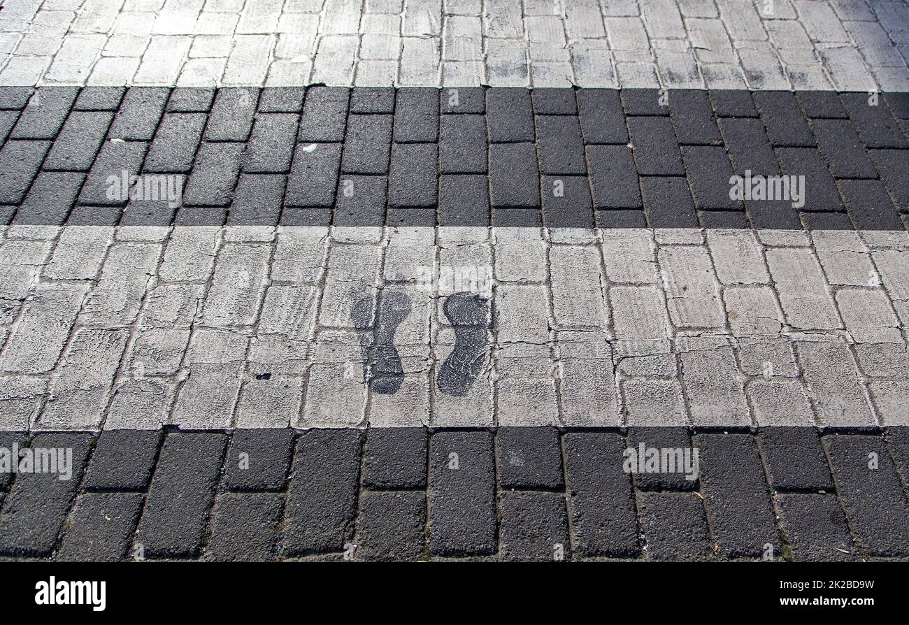 Footprints on zebra crossing Stock Photo - Alamy