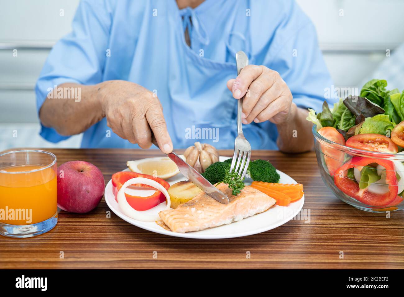 Asian senior or elderly old lady woman patient eating Salmon steak ...