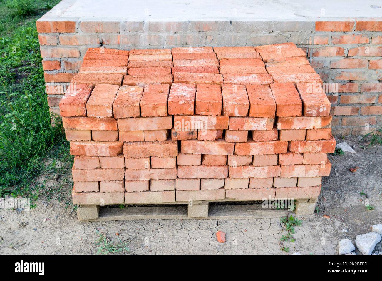The red brick folded neatly on the foundation of the house. Home ...