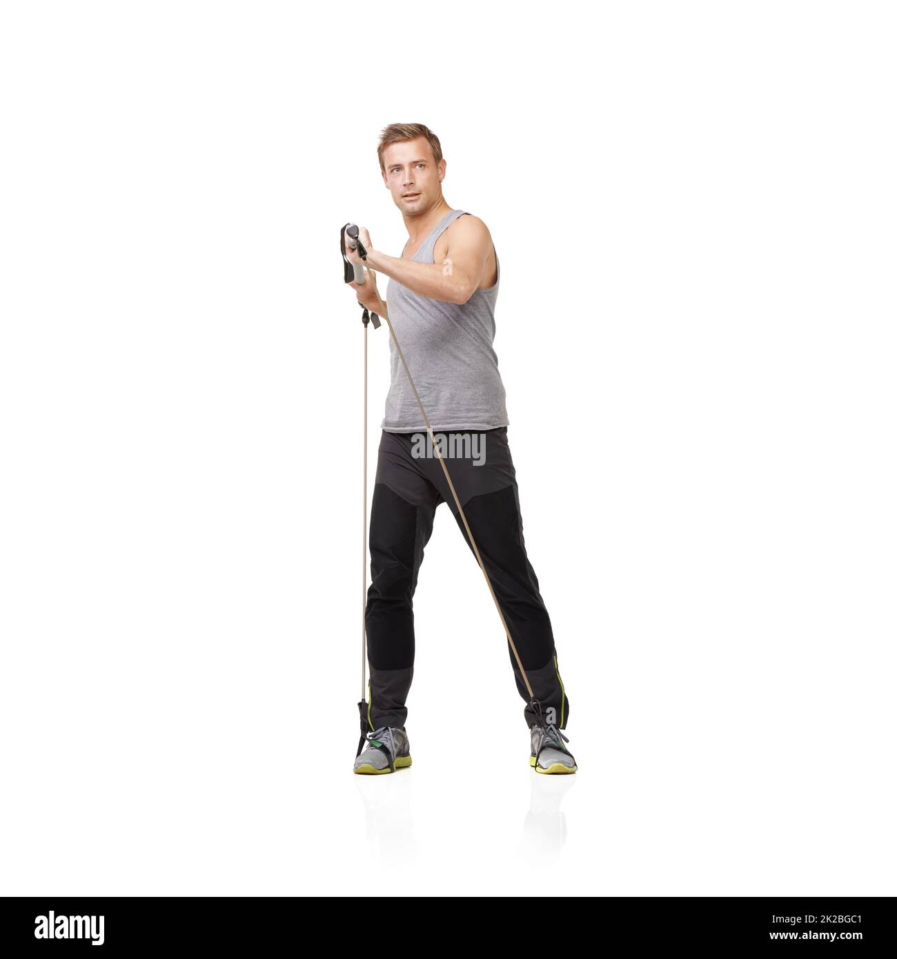 Working His Way Up The Fitness Ladded A Young Man Using A Resistance Band To Tone His Body