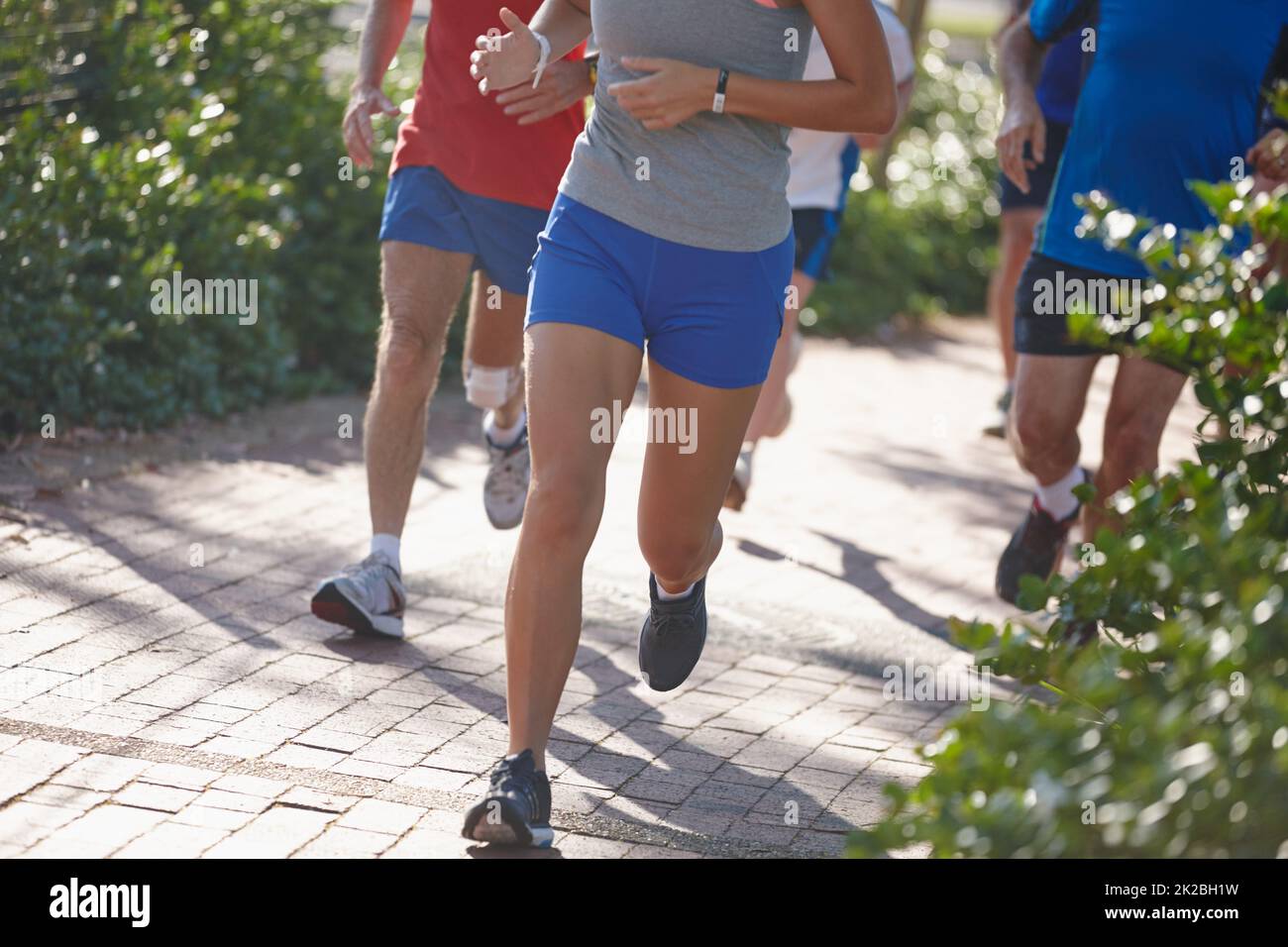 Leading the pack. Cropped shot of a group of people running Stock Photo ...