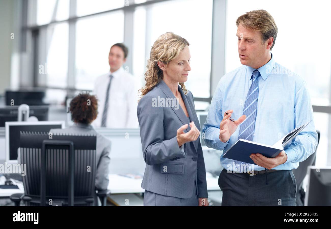 Going through all the important dates. Two mature business executives ...