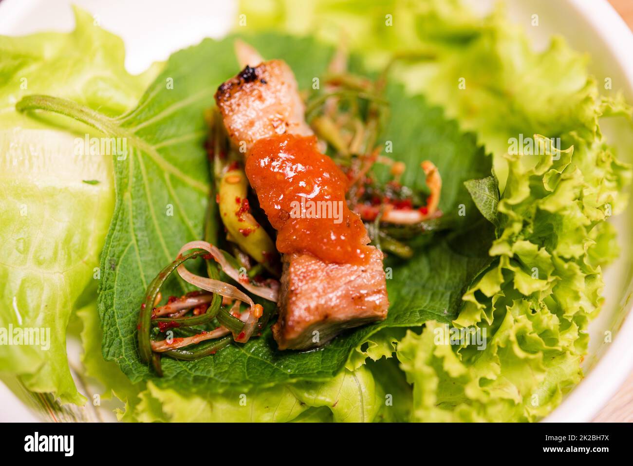grilling meat wrap green vegetable leaf for eat at restaurant Stock ...