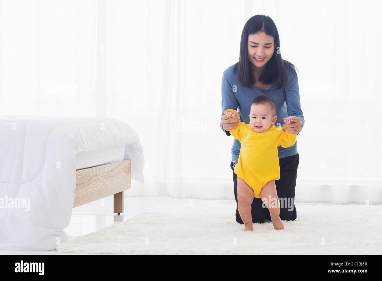 Baby taking first steps hispanic hi-res stock photography and images ...