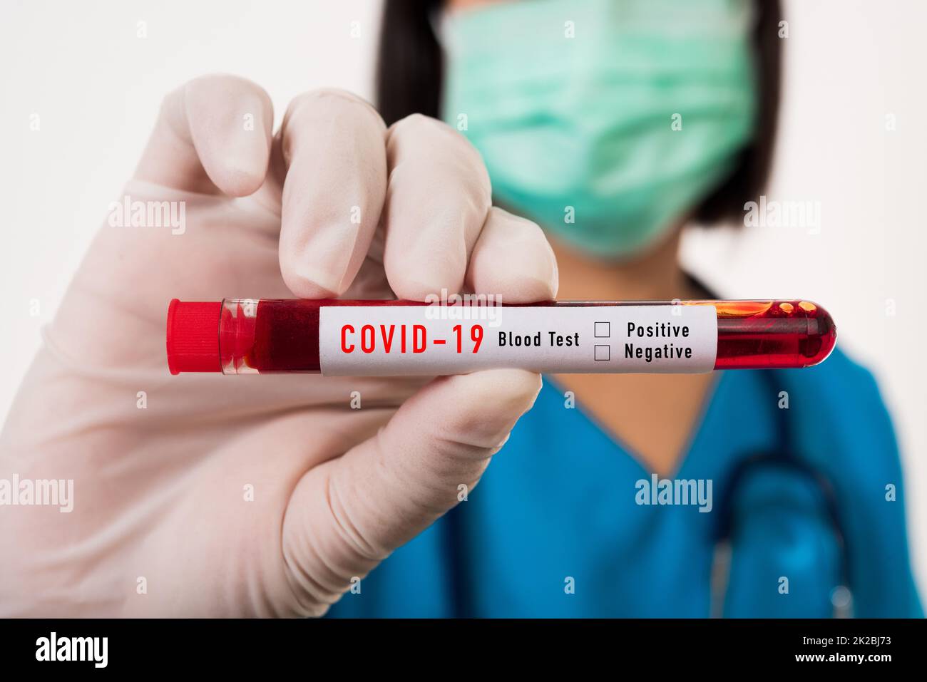 Nurse in blue uniform wear a mask holding test tube sample Coronavirus ...