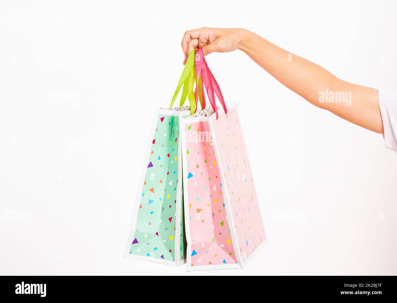 women hand holding colorful multicolor shopping bag many packets Stock ...