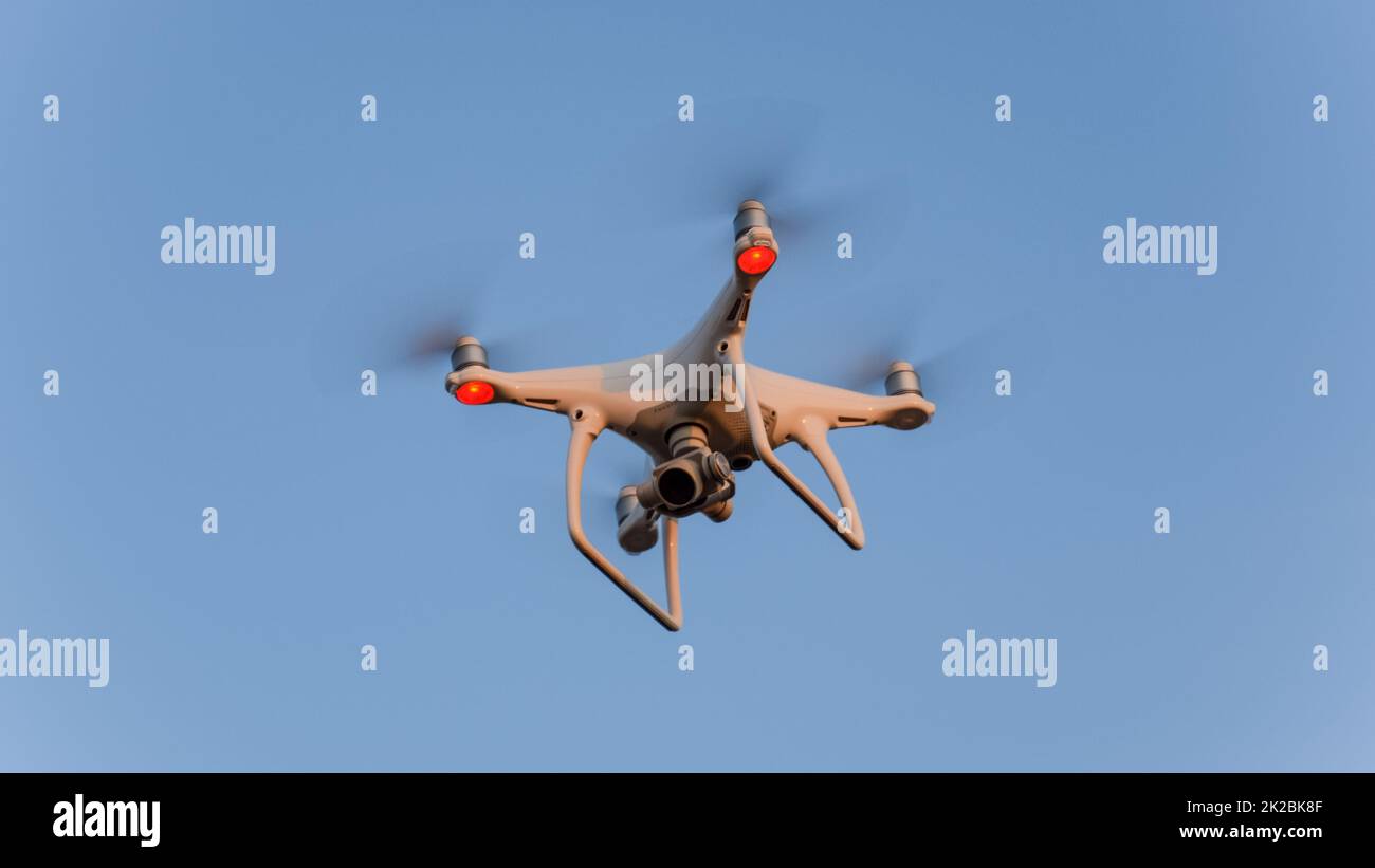 The drone, hovering in the sky. Flight quadrocopters Stock Photo - Alamy