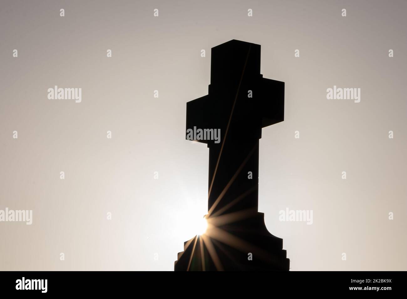 Glowing cross silhouette with sunbeams sunset sunlight and clear ...