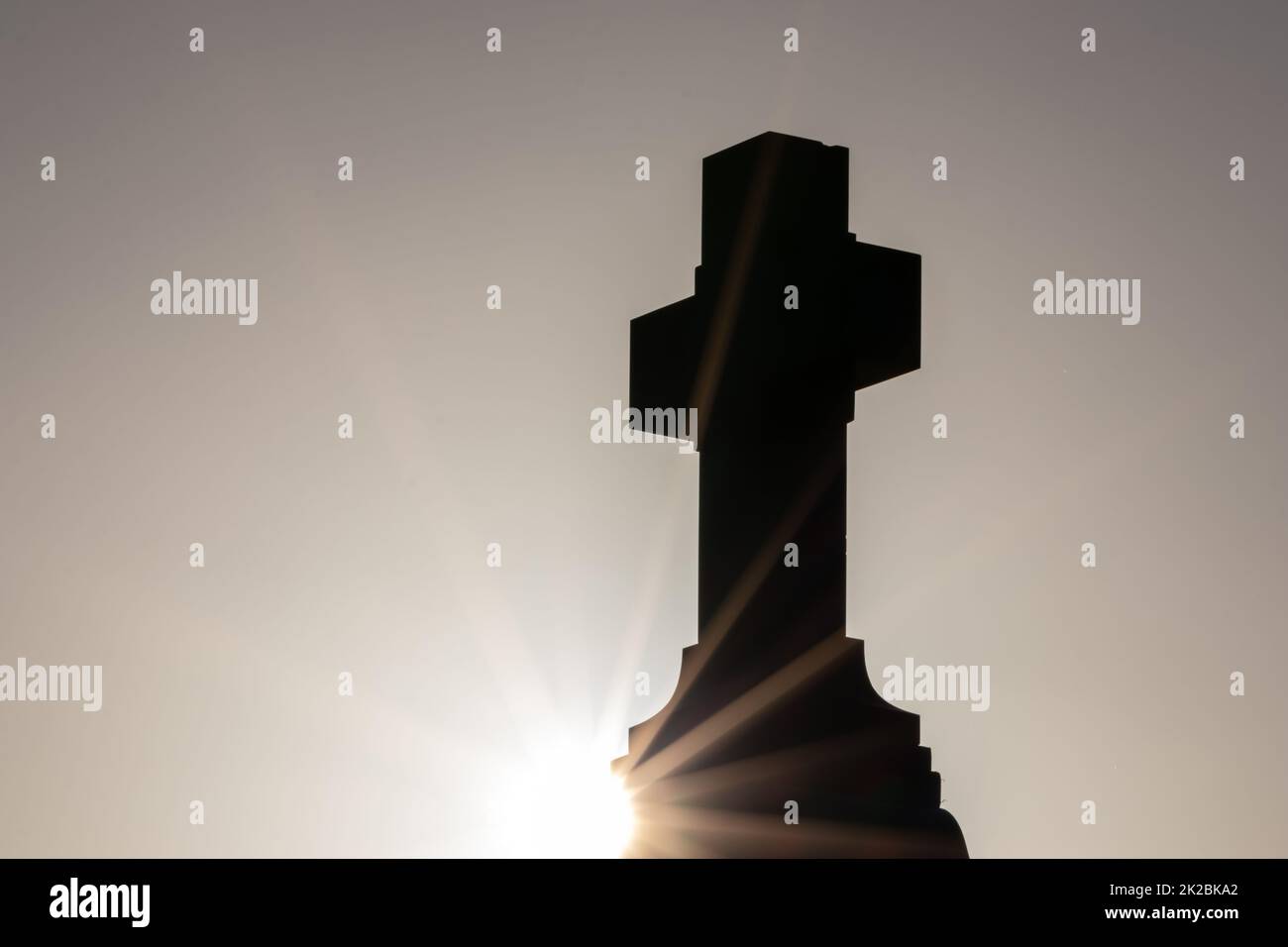 Glowing cross silhouette with sunbeams sunset sunlight and clear ...