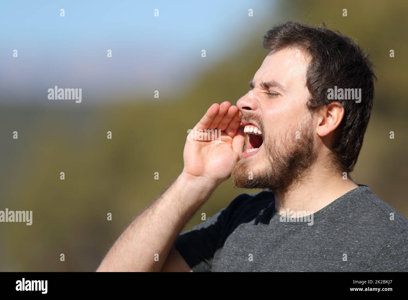 Man shouting loud in nature Stock Photo - Alamy
