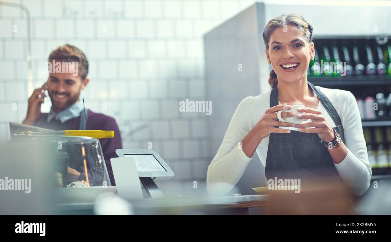 No one knows coffee like we do. Portrait of a young woman having coffee ...