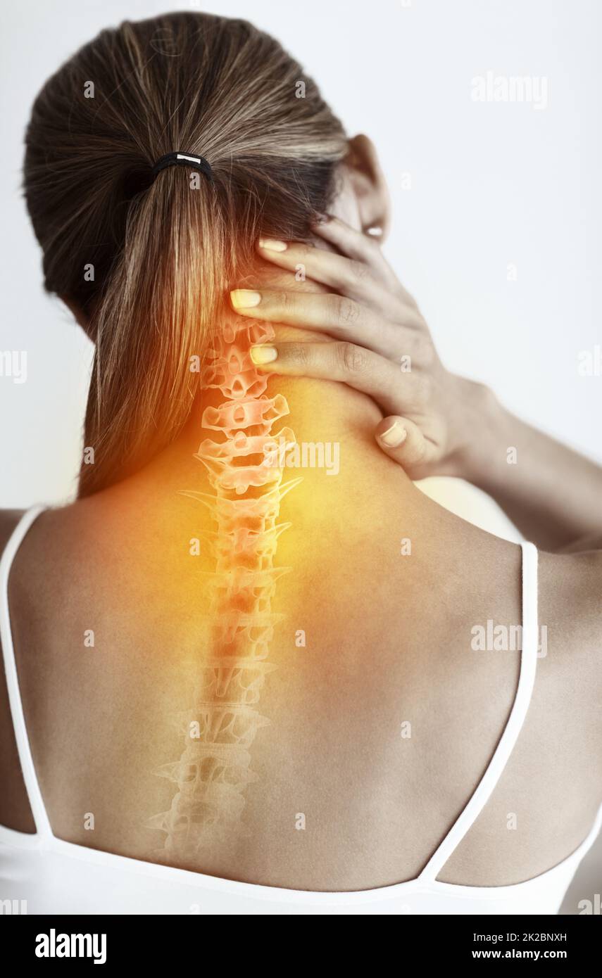 Neck pain can be debilitating. Rear view of young woman suffering from ...