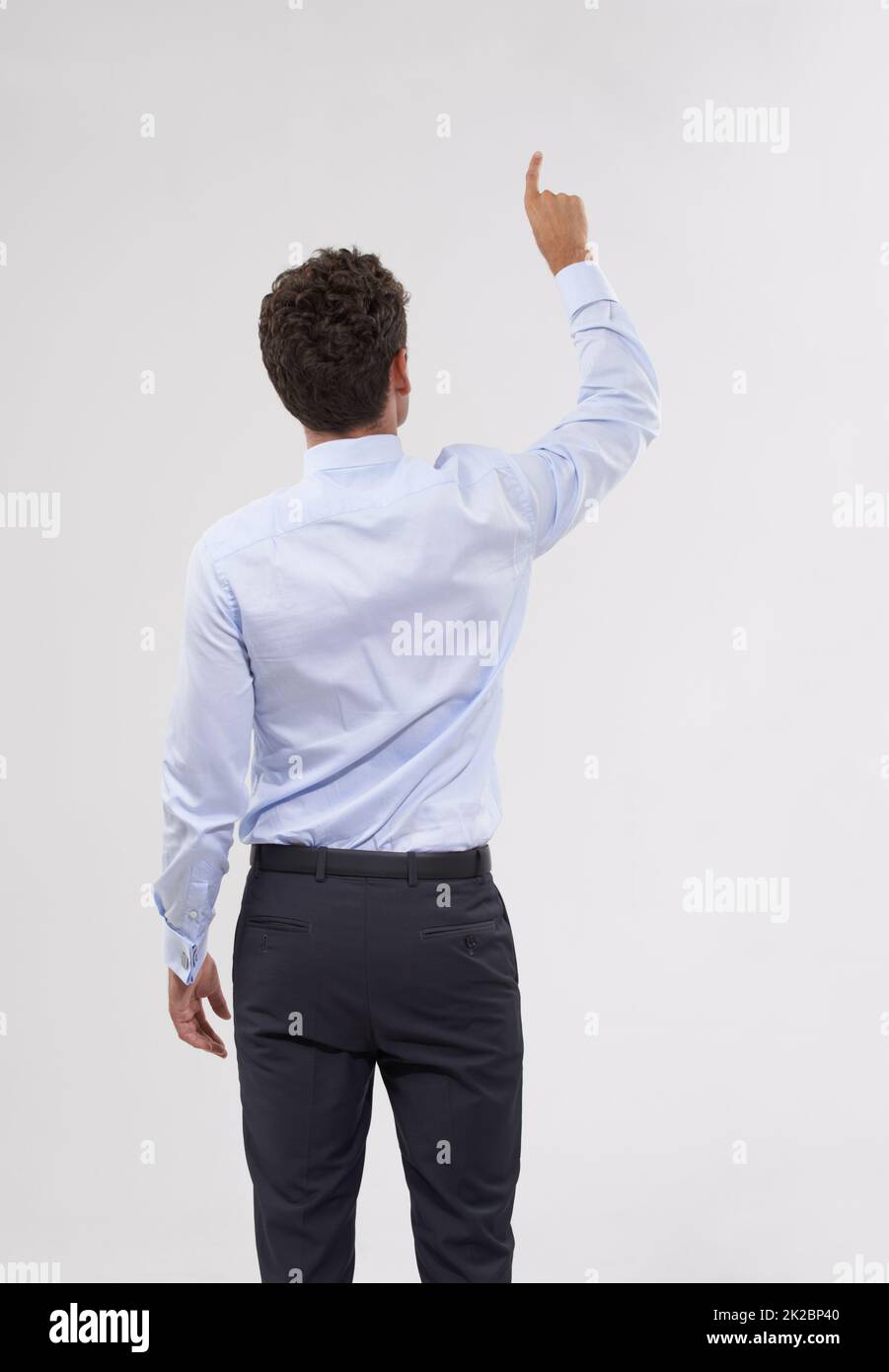 Picking the best option. Rear view of a handsome young businessman ...