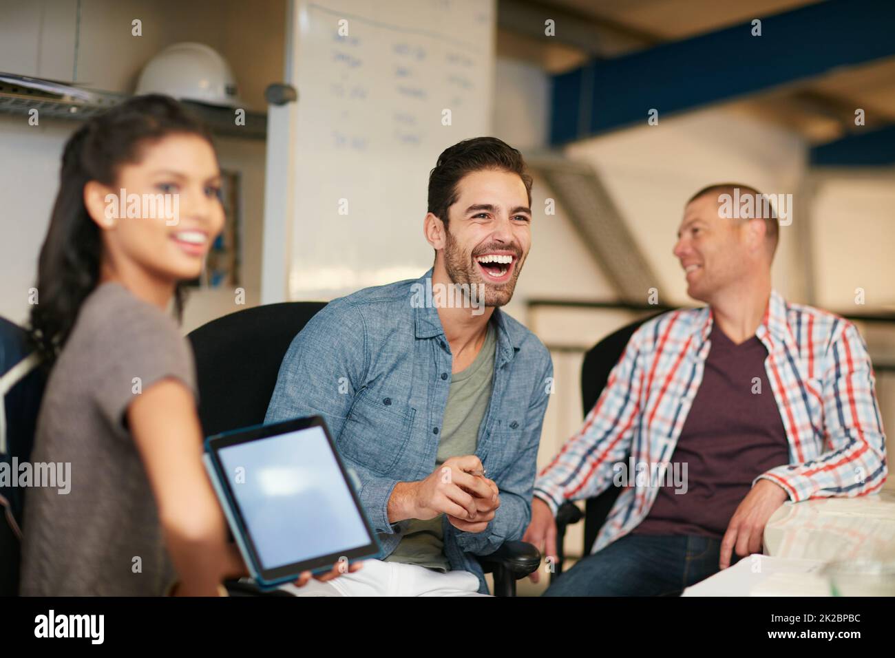 Three work colleagues laughing hi-res stock photography and images - Alamy