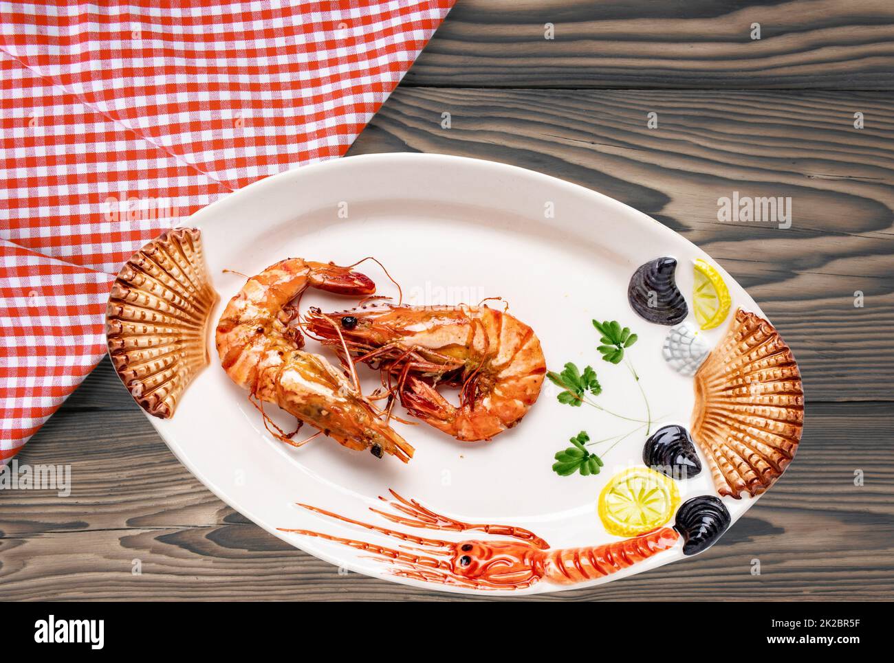 Closeup of fresh grilled large tiger prawns or shrimps on a colourful ...
