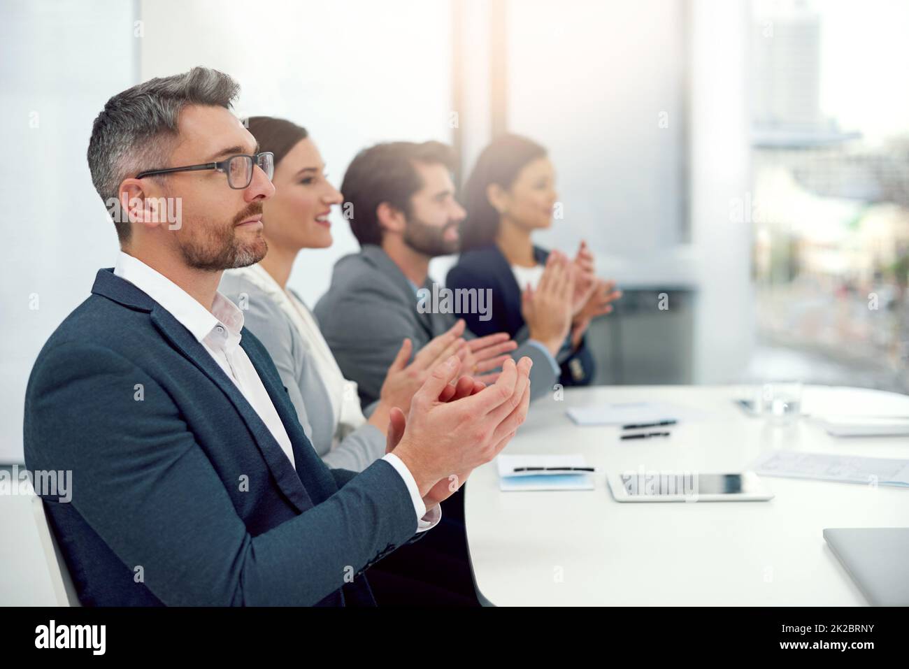 Celebrating exceptional work. Cropped shot of a group of businesspeople ...