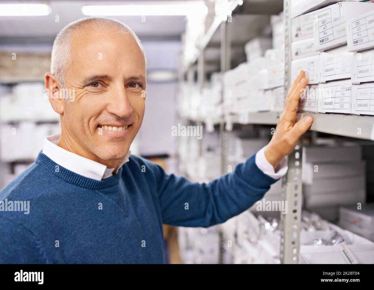 Ive got your order put together. Portrait of a man searching shelves in ...