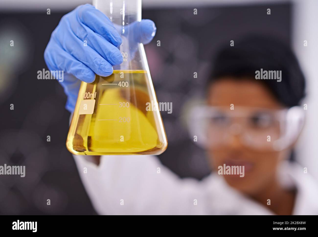 Analysing the result of the experiment. A young scientist in protective ...
