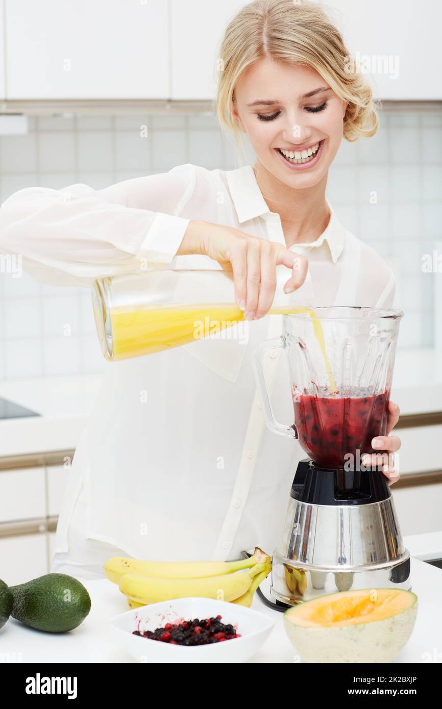 Attractive woman pouring orange juice hi-res stock photography and ...