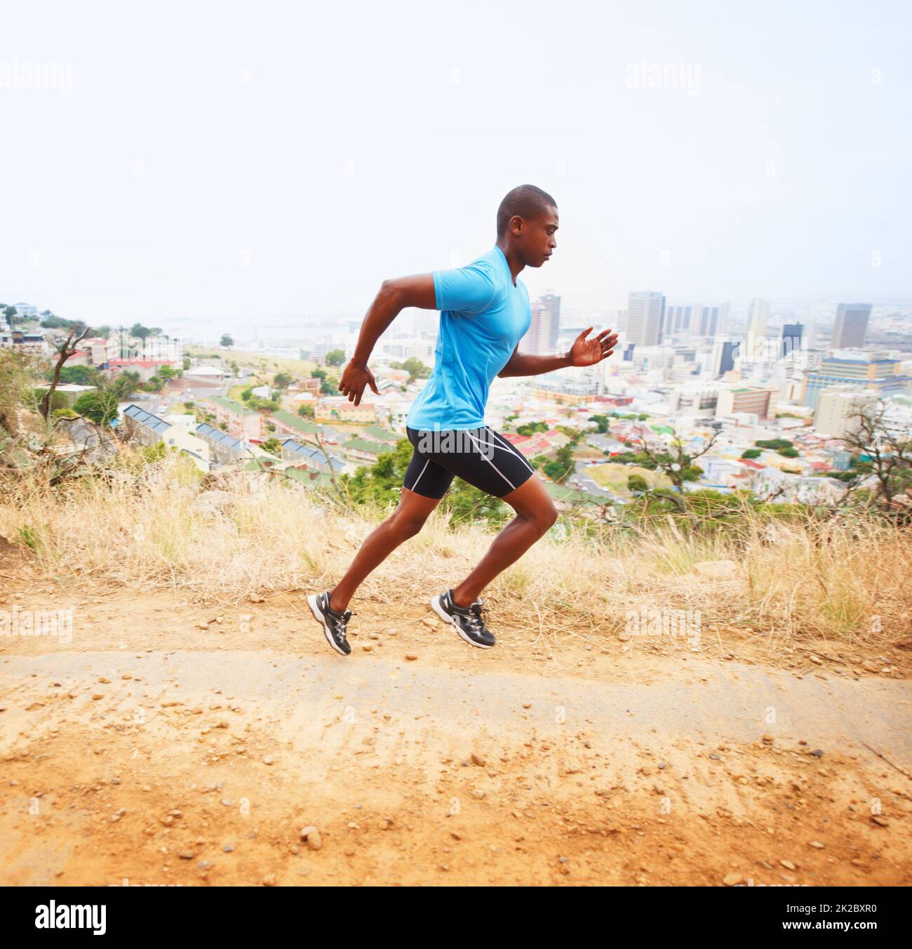 Ive gotta beat my time. A young man running along a nature trail with ...